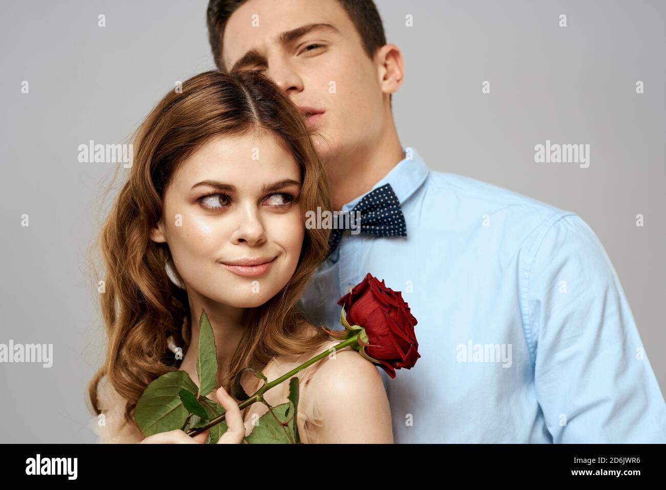 Young couple romance hug relationship dating red rose light studio ...