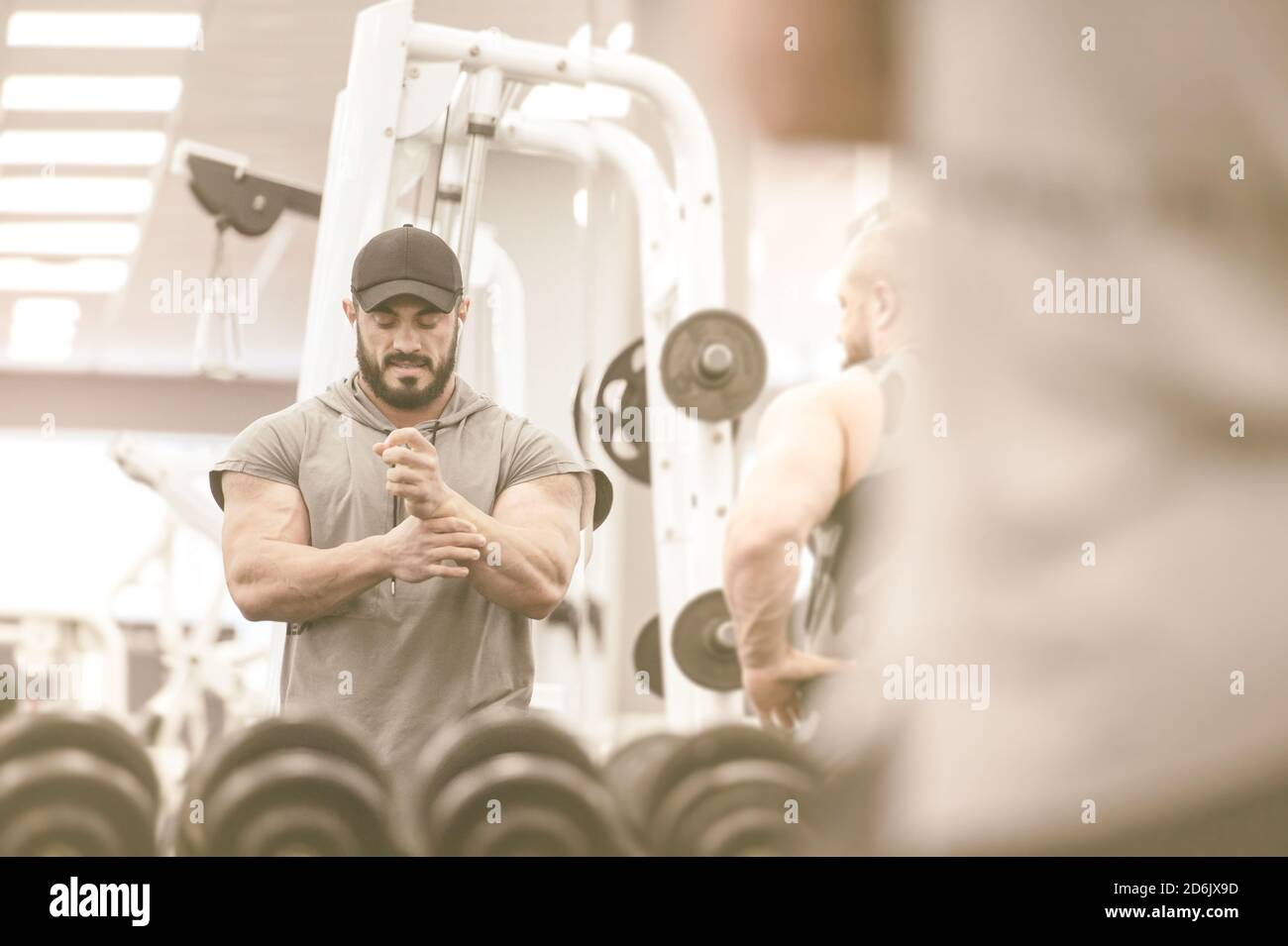 sport joint wrist injury concept of young bearded man athlete holding ...