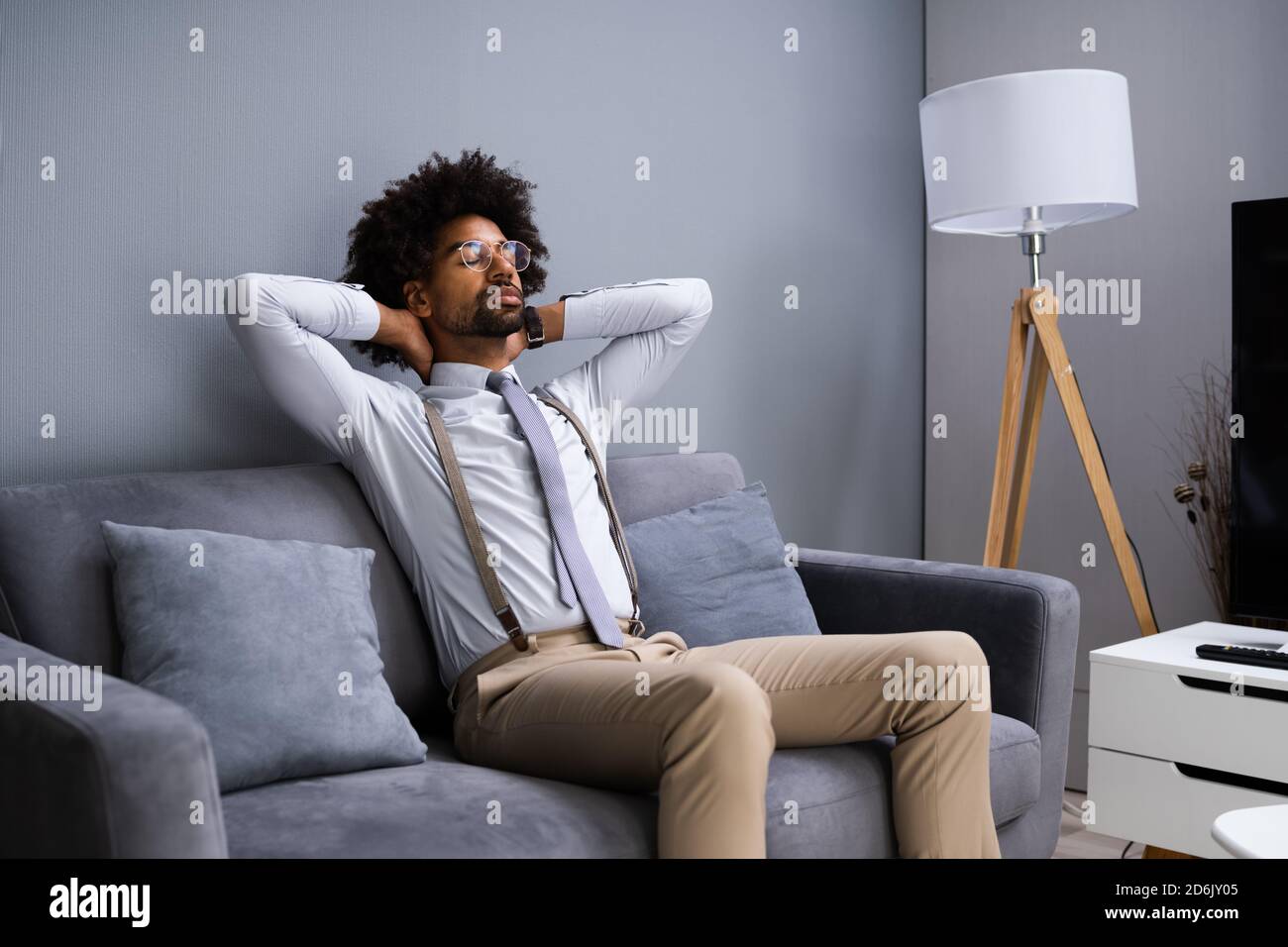 Young Man Sitting On Couch Relaxing At Home Stock Photo - Alamy