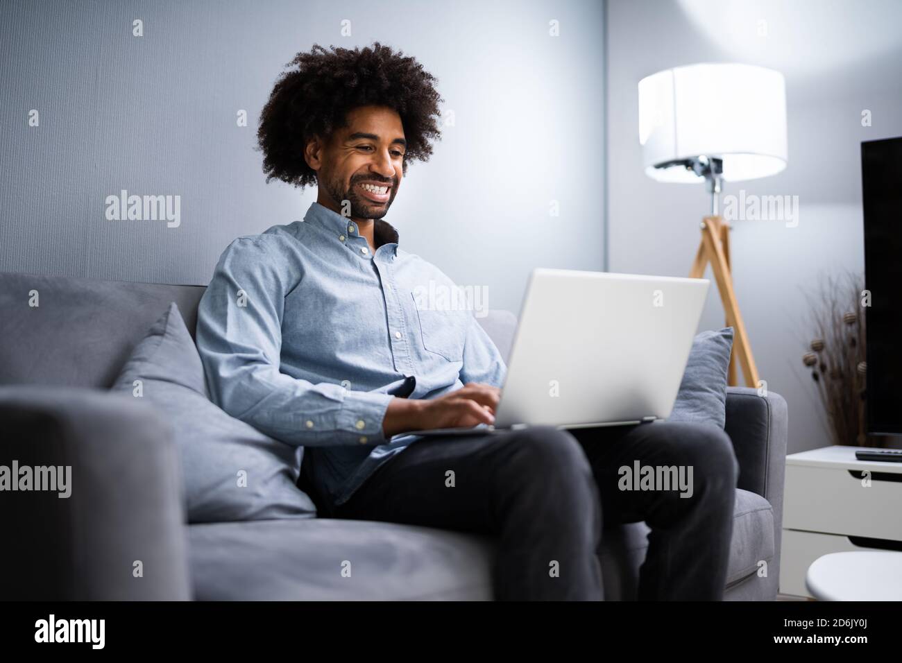 African American Man Using Laptop Computer Online Stock Photo - Alamy