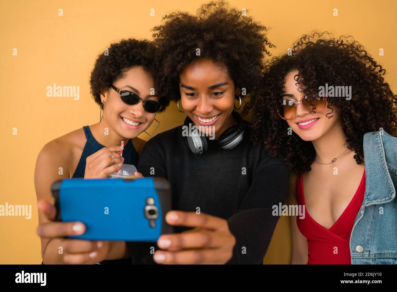 Portrait Of Three Afro Friends Taking Selfies With Her Mophile Phone