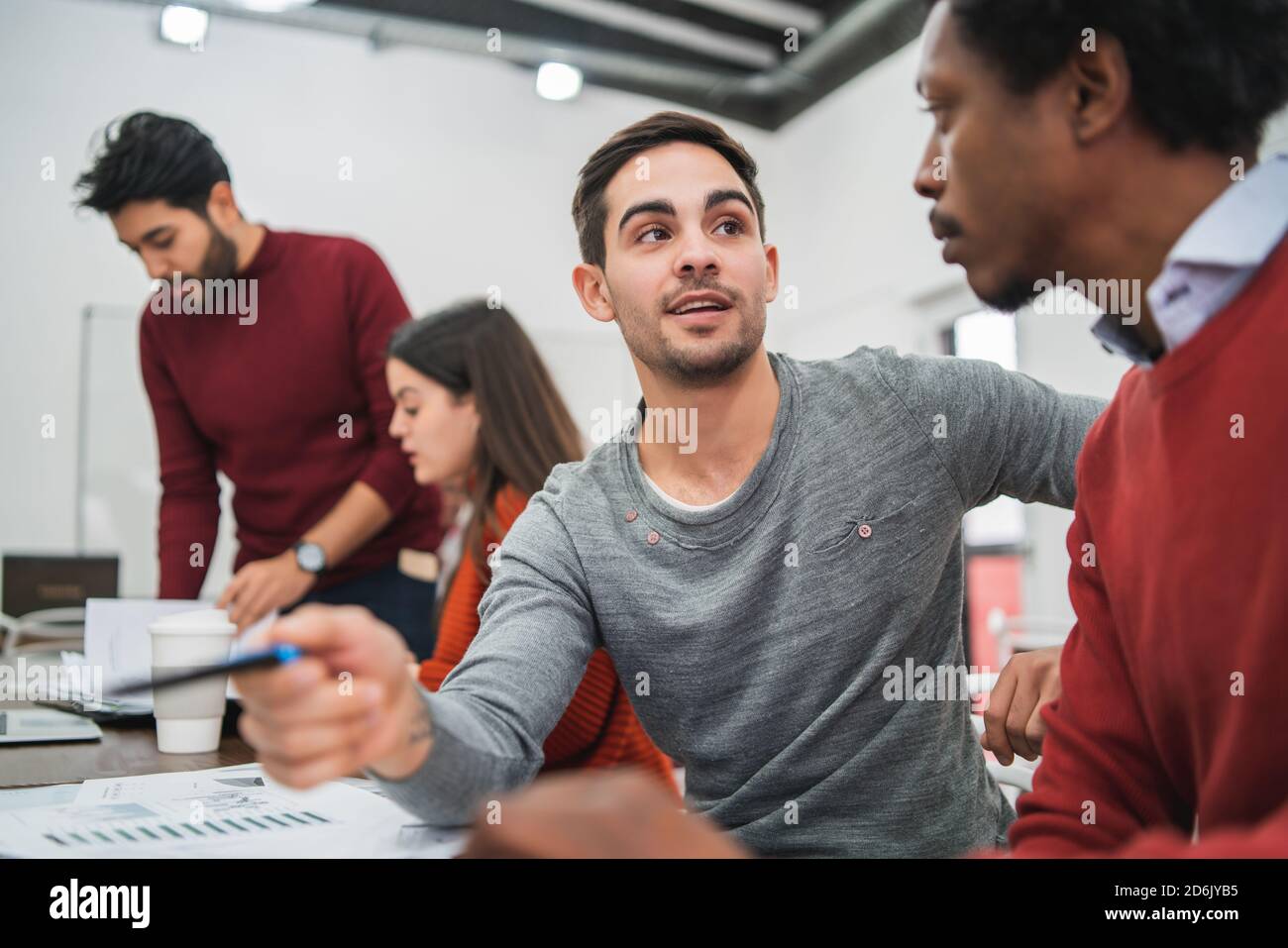 Two creative designers working in a project together and sharing new ...