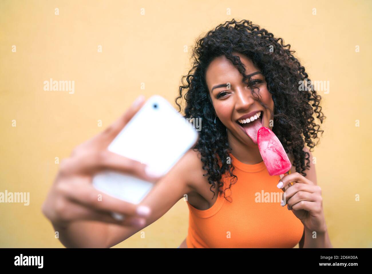 Portrait Of Afro Woman Taking Selfies With Her Mophile Phone While