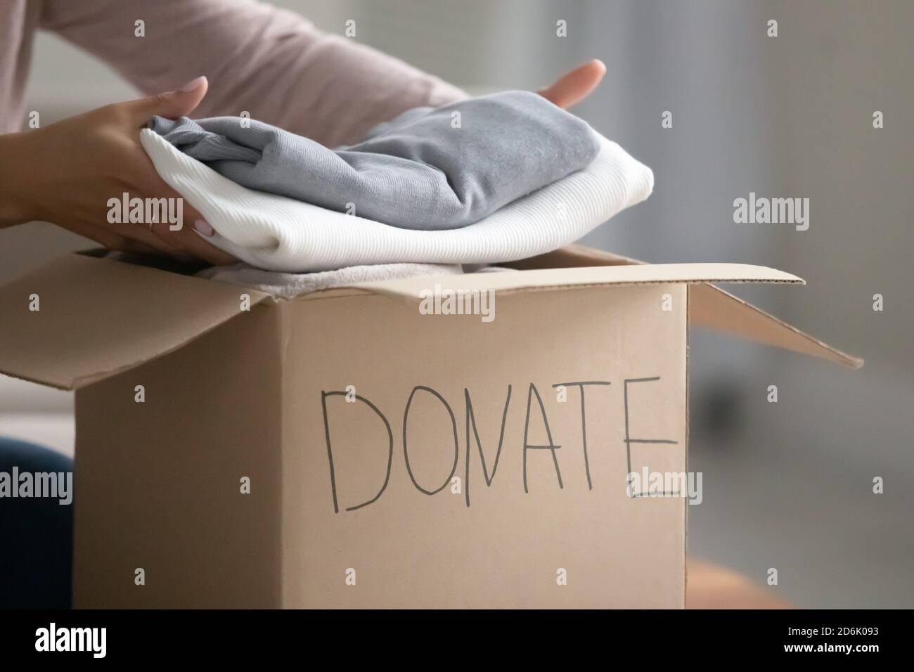 Woman packing box clothes hi-res stock photography and images - Alamy