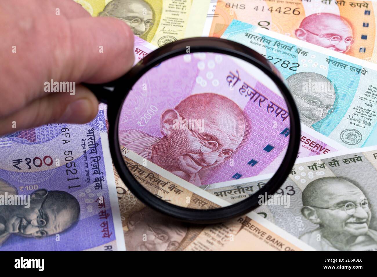 Indian rupee in a magnifying glass Stock Photo - Alamy