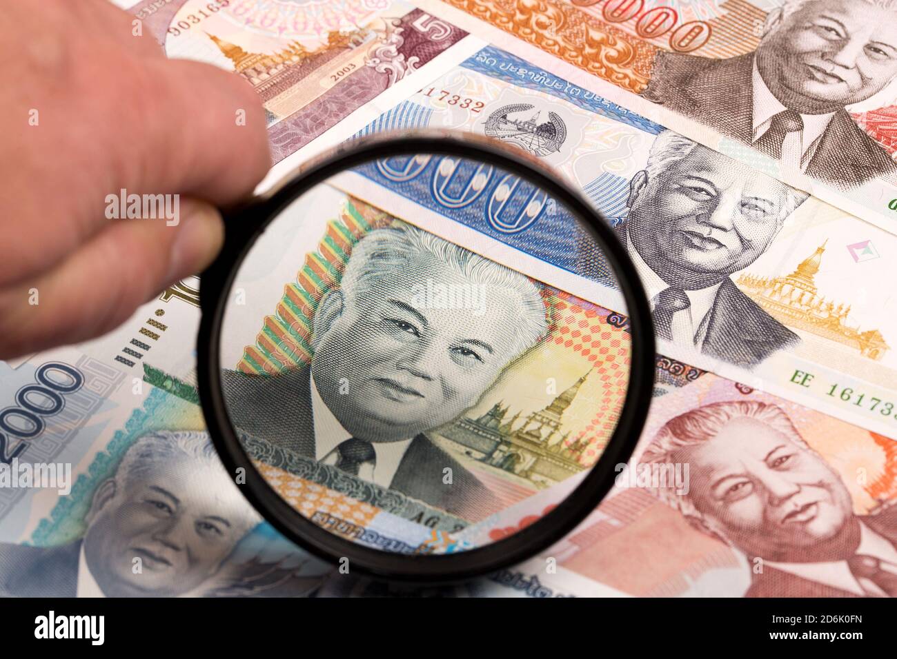 Lao kip in a magnifying glass Stock Photo - Alamy