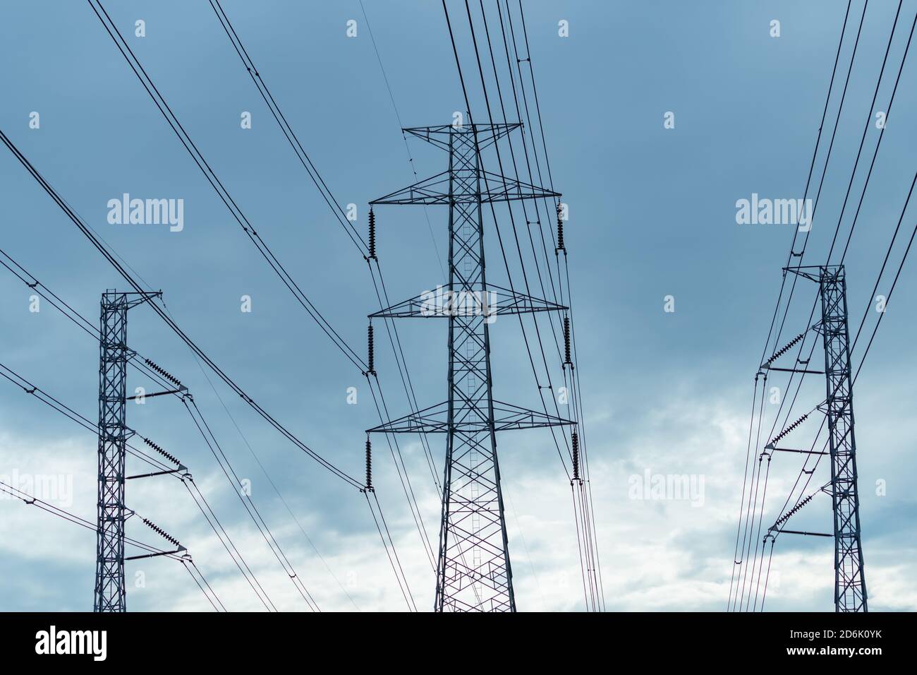 High voltage electric pylon and electrical wire against blue sky and ...