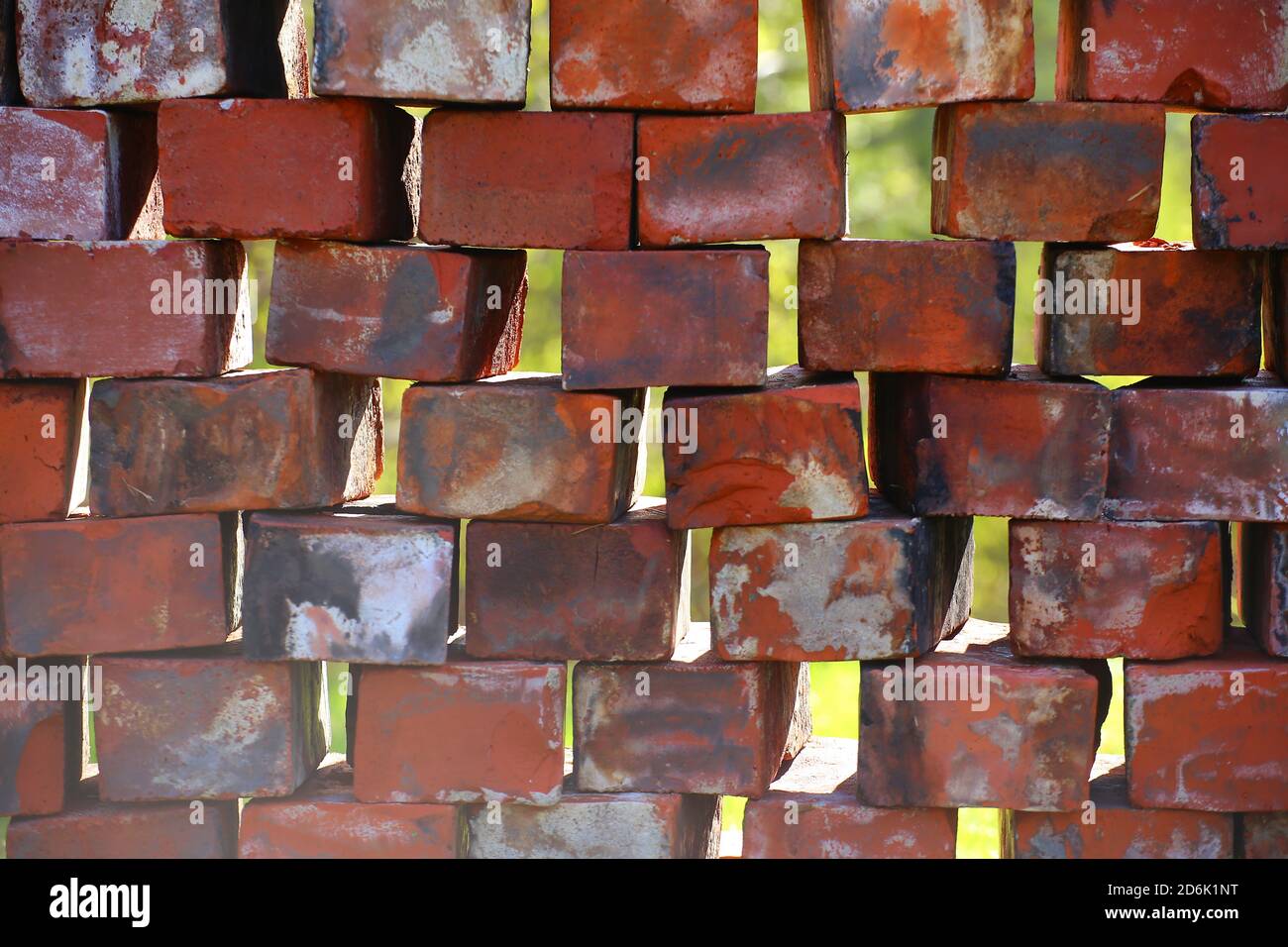 Stacked used bricks in front of blurred background Stock Photo - Alamy