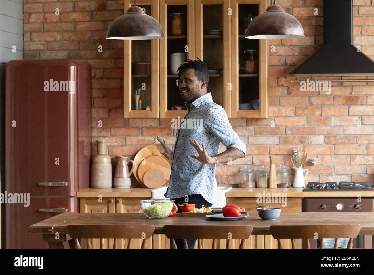 Happy biracial man dance cooking at home kitchen Stock Photo - Alamy