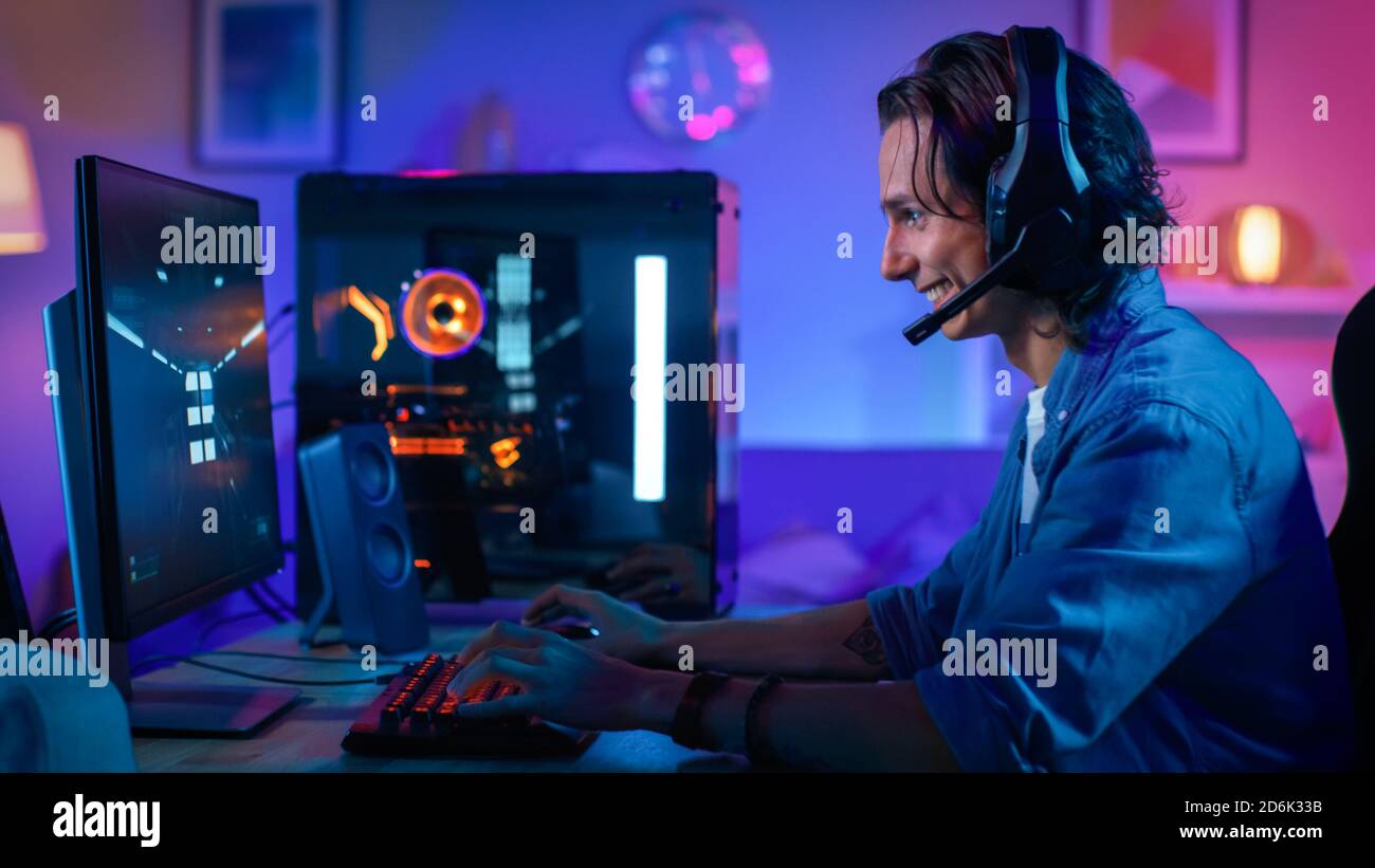 Excited Gamer Playing First-Person Shooter Online Video Game on His ...