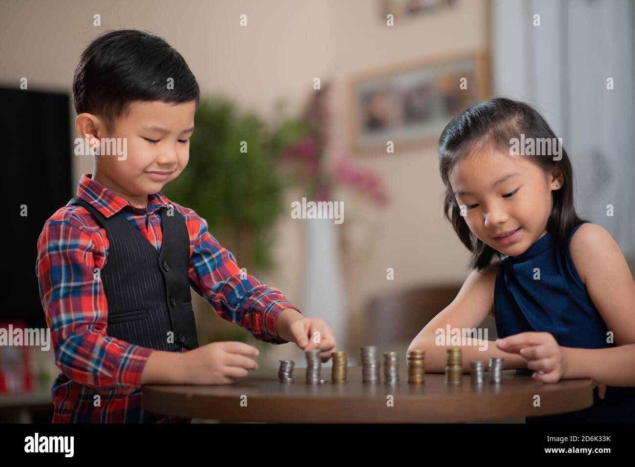 Asian children, managing finances, counting money Stock Photo - Alamy