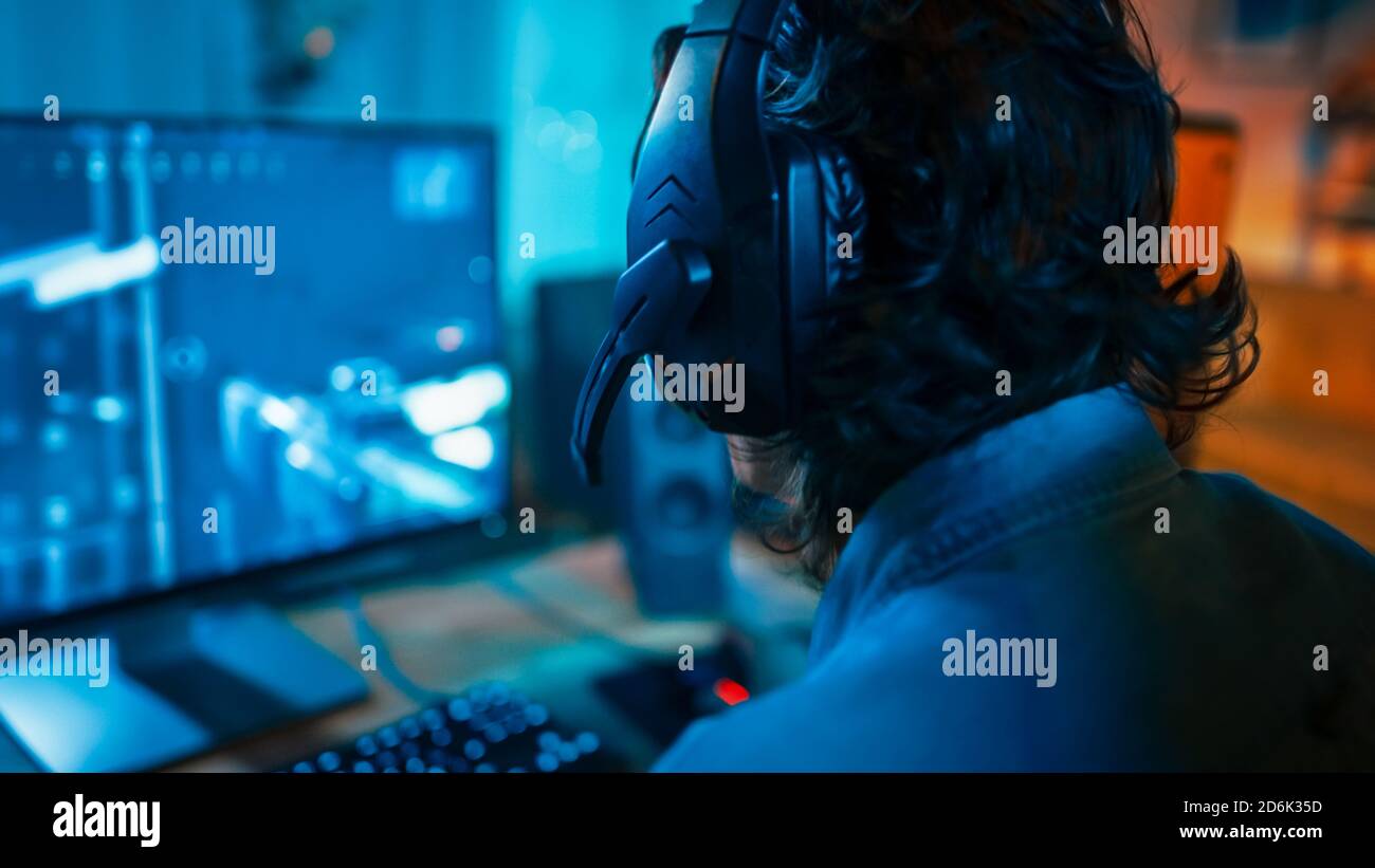 Close Up Back Shot of a Gamer Wearing a Headset with Mic and Playing ...