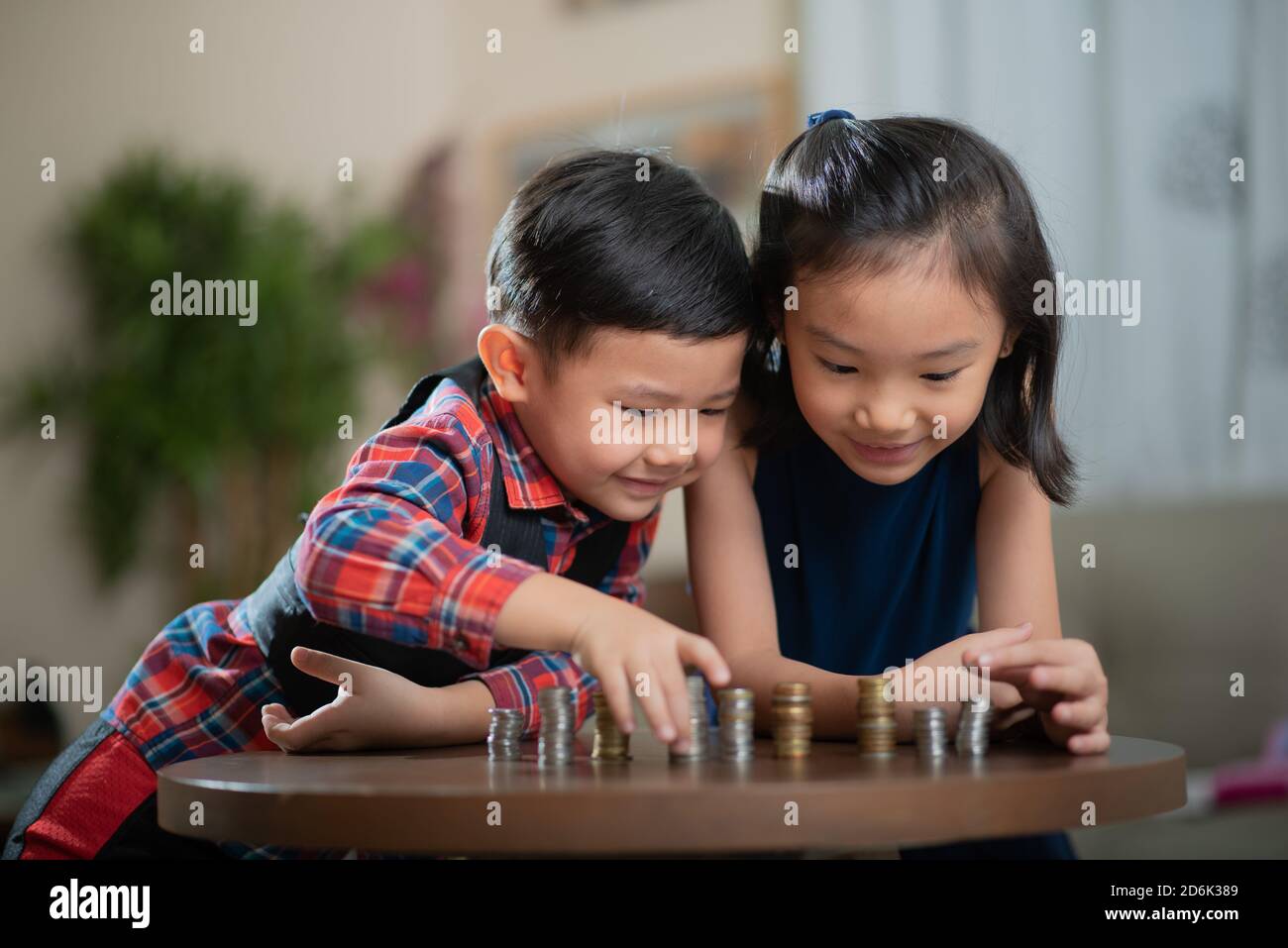 Asian children, managing finances, counting money Stock Photo - Alamy
