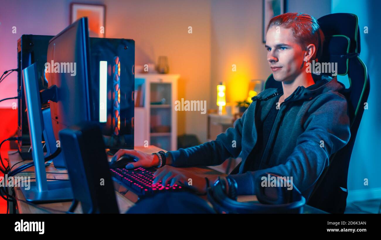 Cheerful Gamer Playing First-Person Shooter Online Video Game on His ...