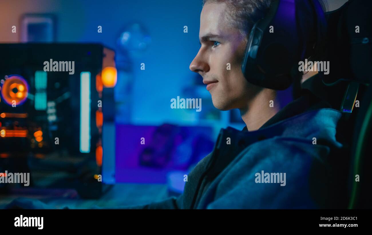 Happy Gamer and Blogger in Headset with a Mic Playing Shooter Online ...