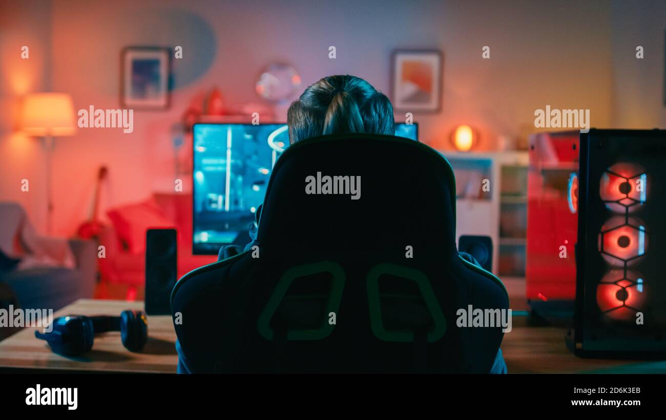 Back Shot of a Gamer Playing in First-Person Shooter Online Video Game ...