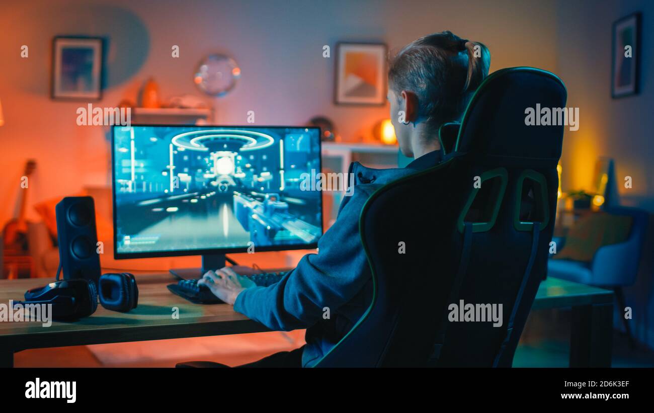 Back Shot of a Gamer Playing First-Person Shooter Online Video Game on ...