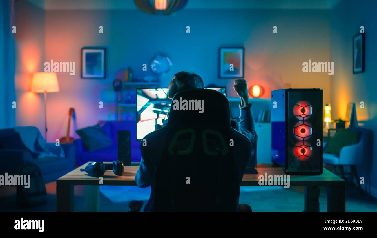 Back Shot of a Gamer Playing and Winning in First-Person Shooter Online ...