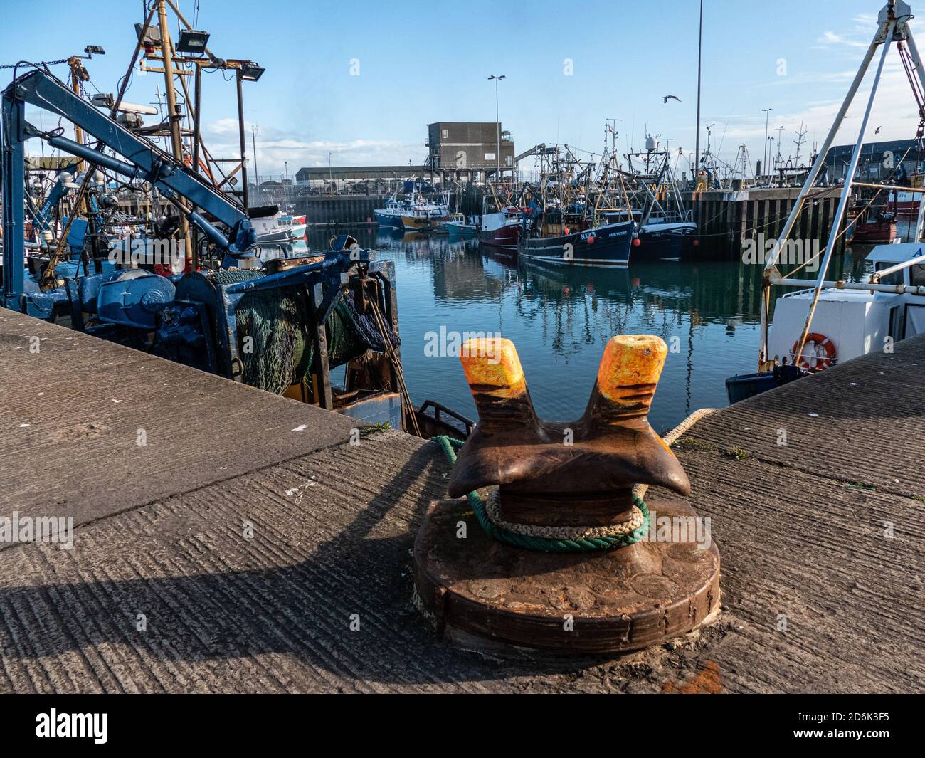 Landscape view of a corner mooring post at Portavogie fishing boat ...