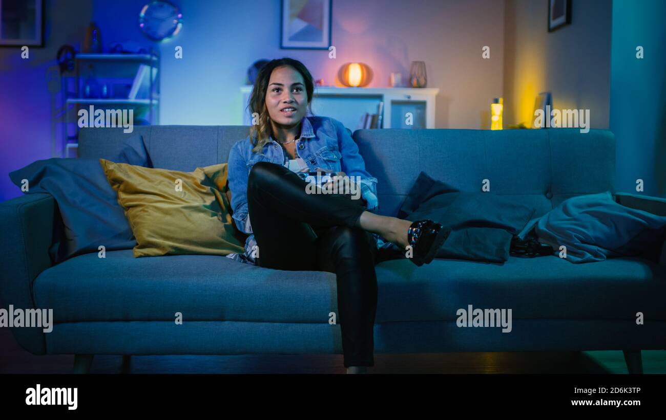 Beautiful Excited Young Black Gamer Girl Sitting on a Couch and Playing ...