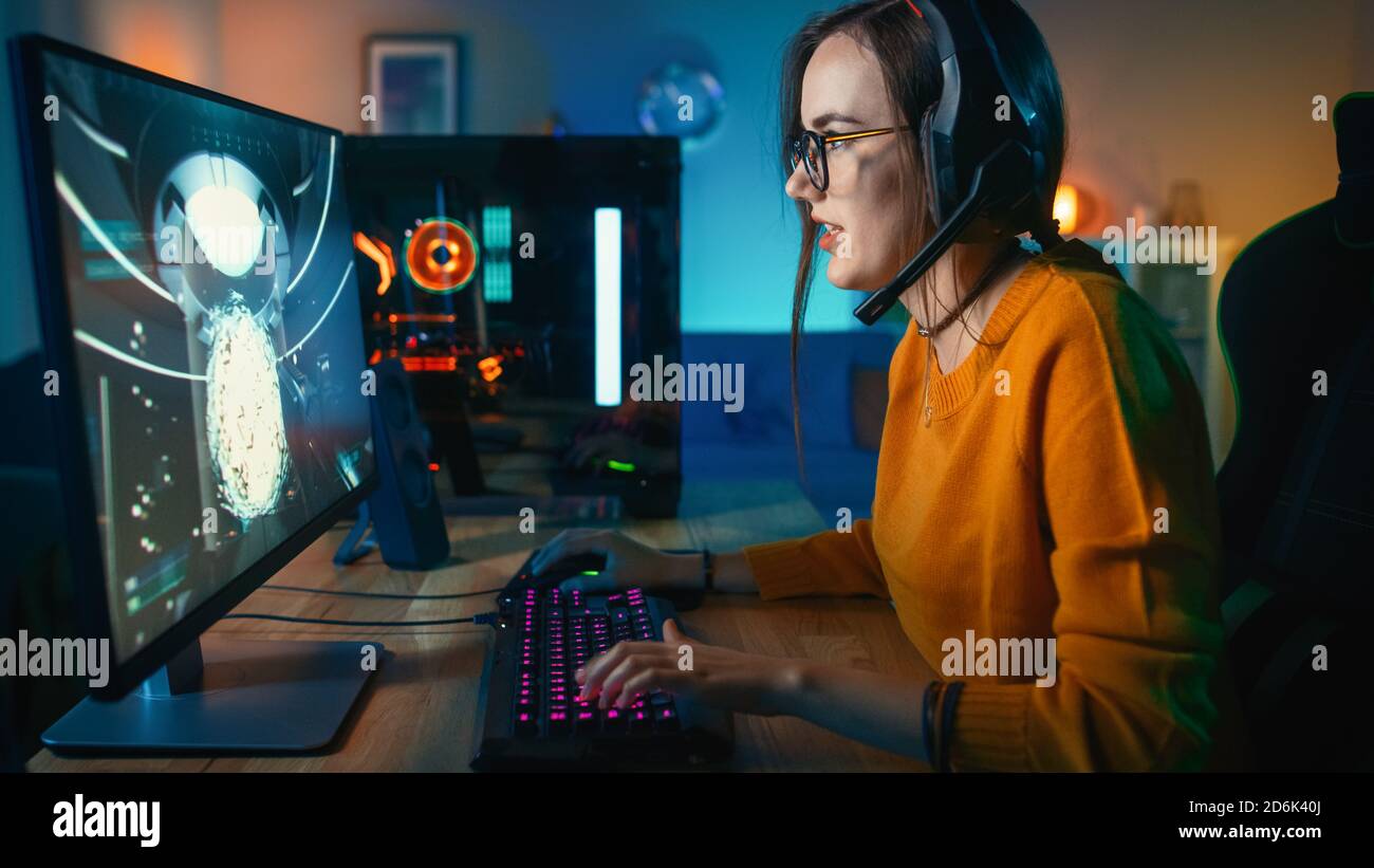 Excited Gamer Girl in Headset with a Mic Playing Online Video Game on ...