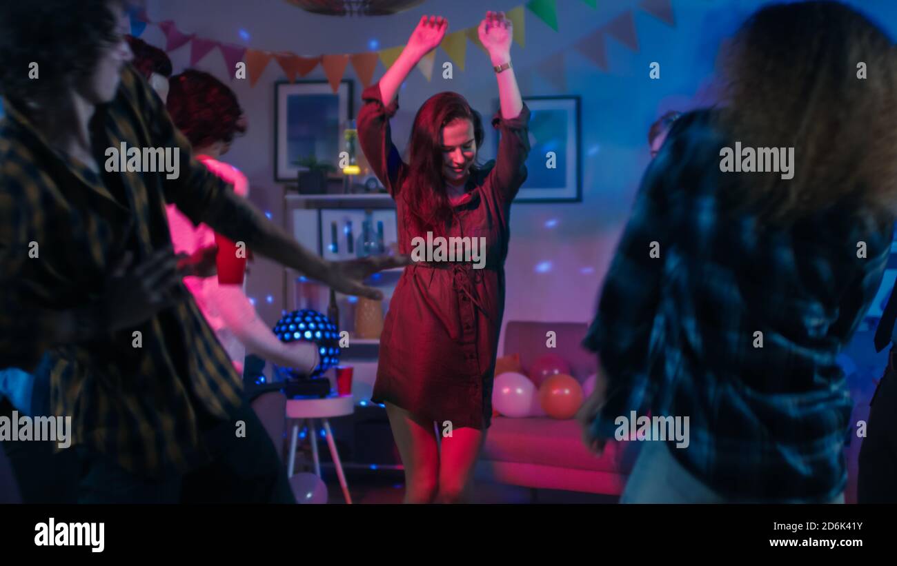 At the College House Party: Young Girl Dances in the Middle of a Circle ...