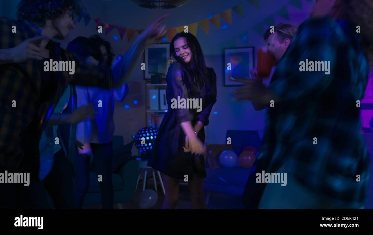 At the College House Party: Young Girl Dances in the Middle of a Circle ...