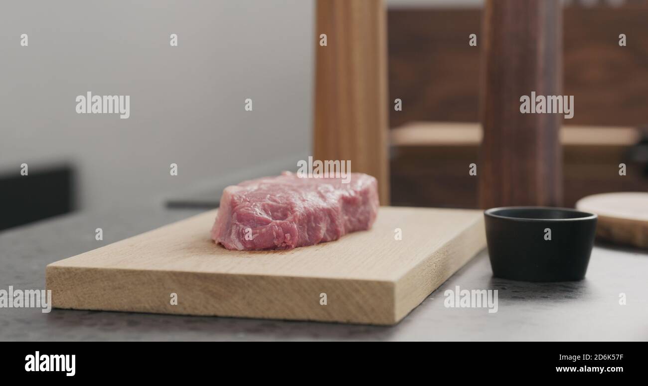 raw ribeye steak on oak wood board, wide photo Stock Photo - Alamy