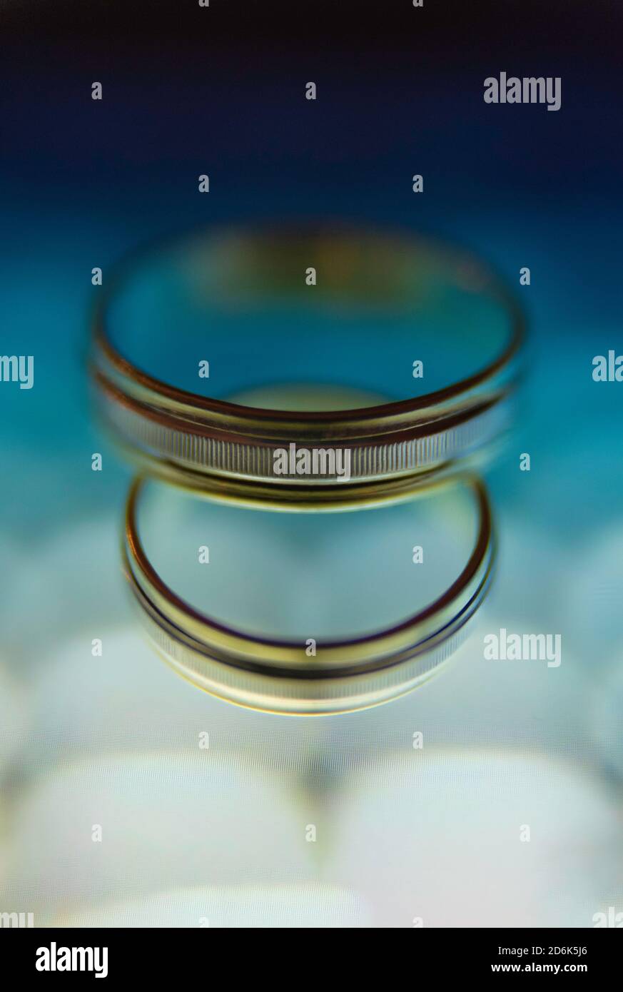 wedding rings in cold colors with reflection Stock Photo - Alamy