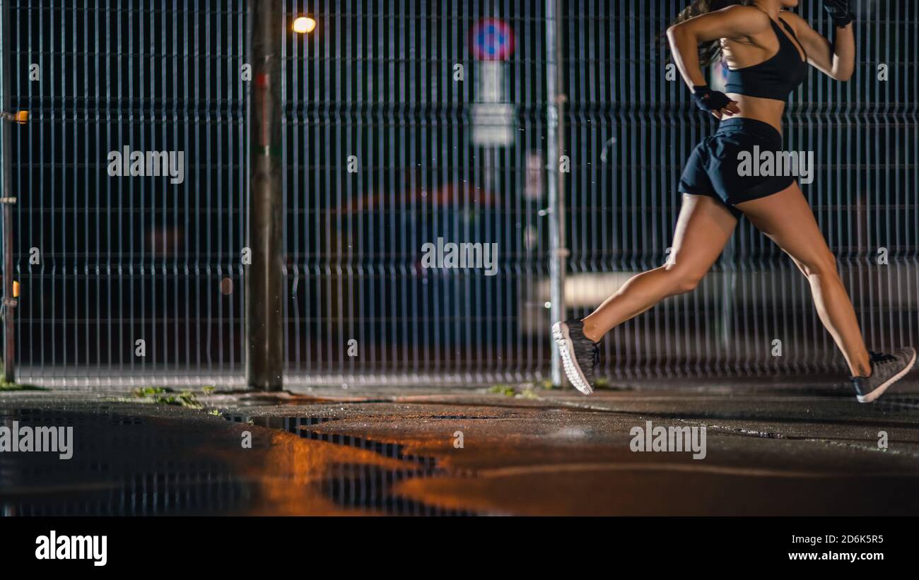 Beautiful Energetic Fitness Girl is Sprinting in a Fenced Outdoor ...