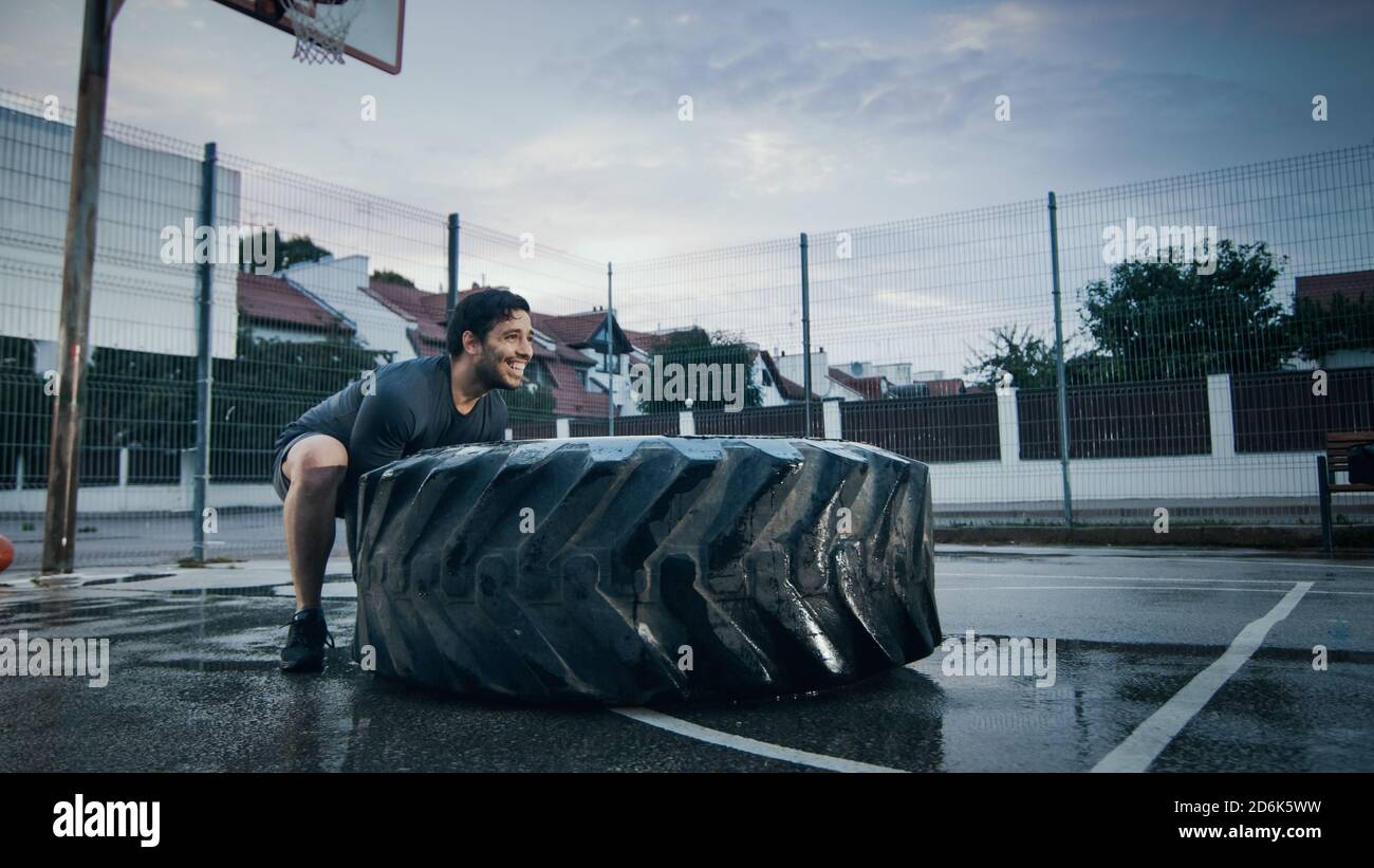 Sport man lifting big tire hi-res stock photography and images - Alamy