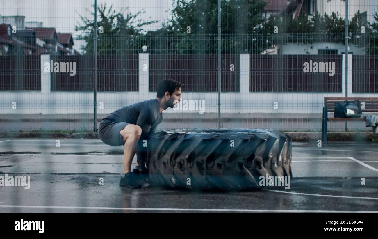 Strong man lifting tire hi-res stock photography and images - Alamy