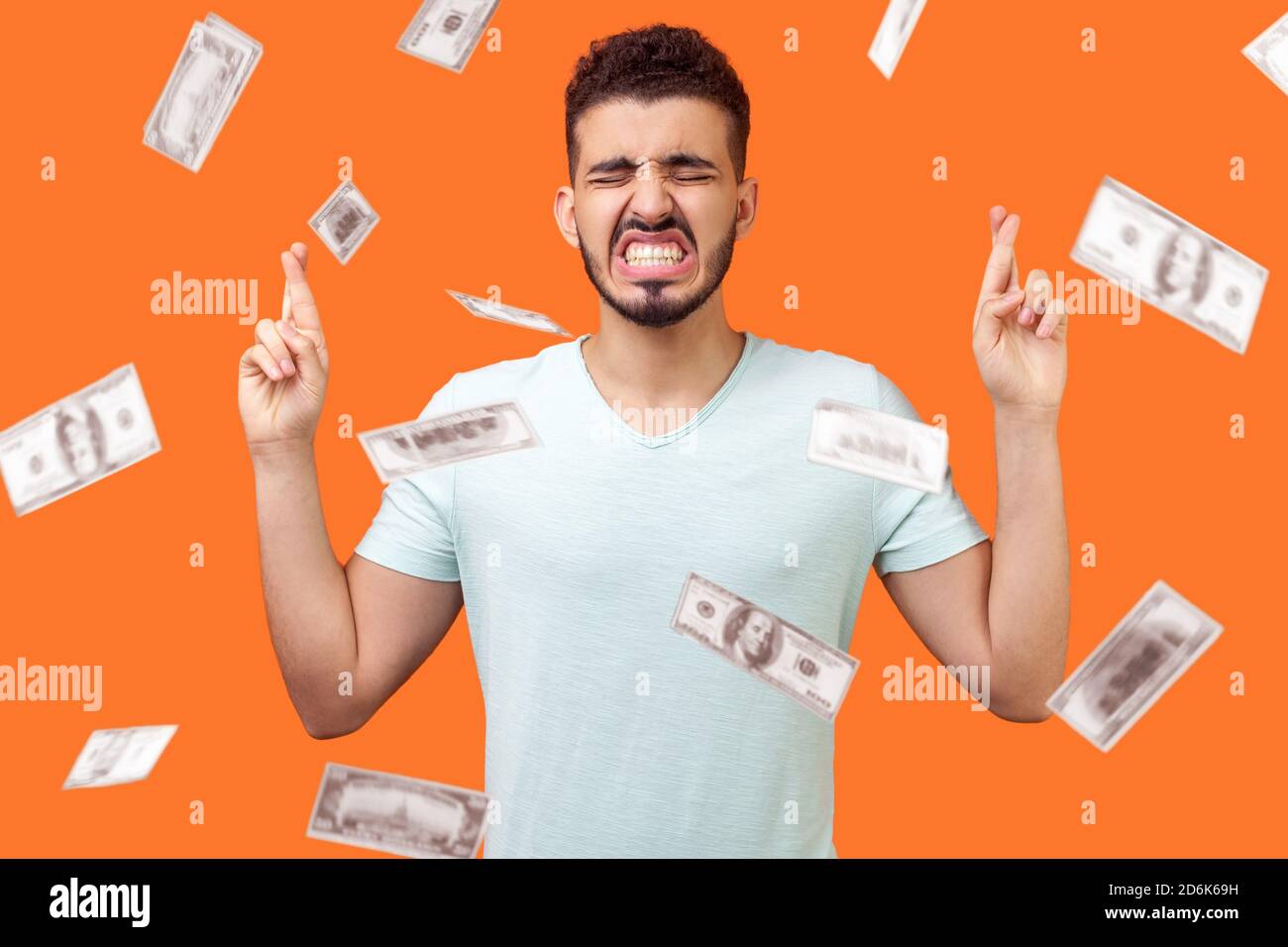 Hope to win money. Portrait of hopeful man standing, closed eyes and ...
