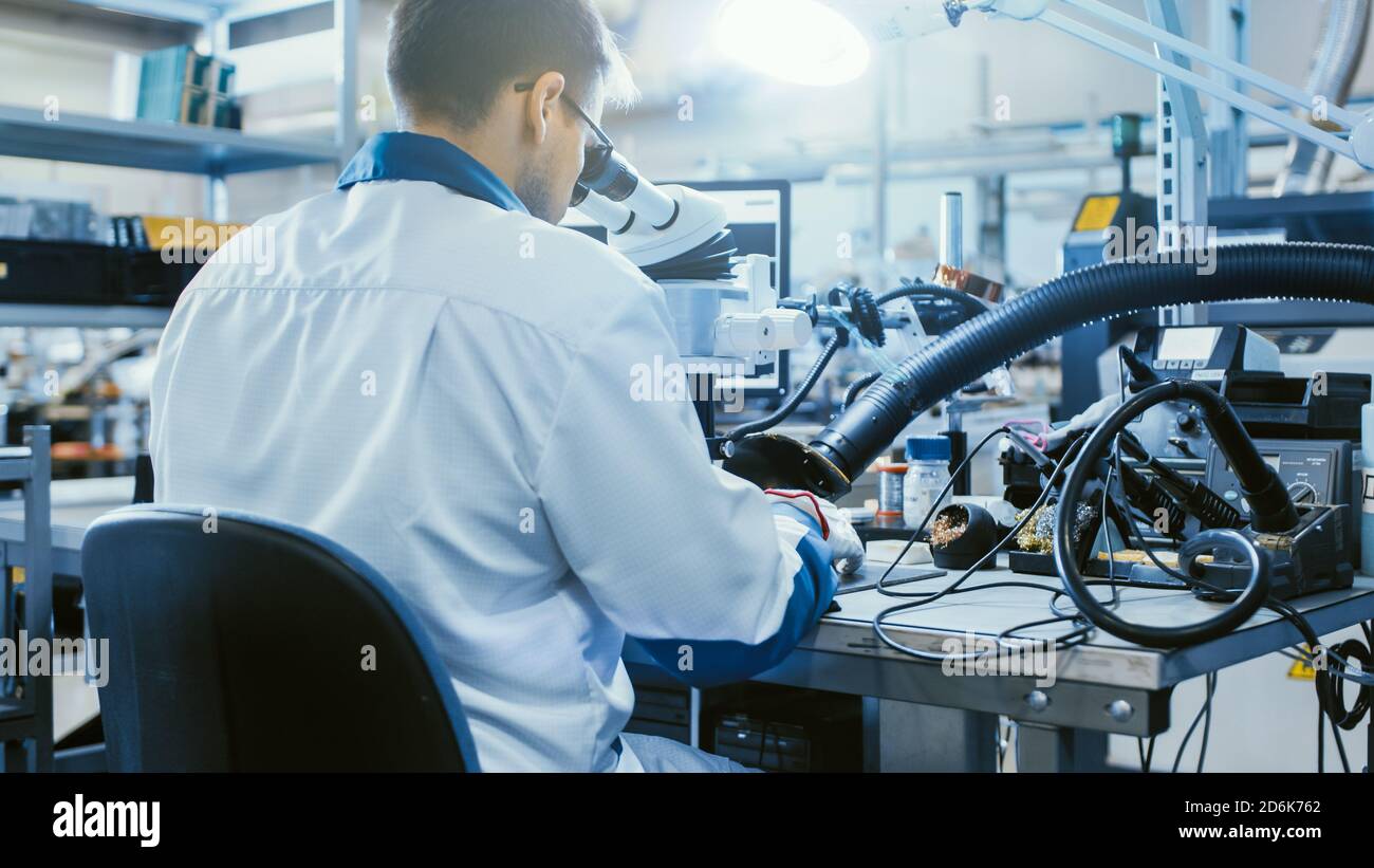 Back View Shot of an Electronics Factory Worker in White Work Coat ...