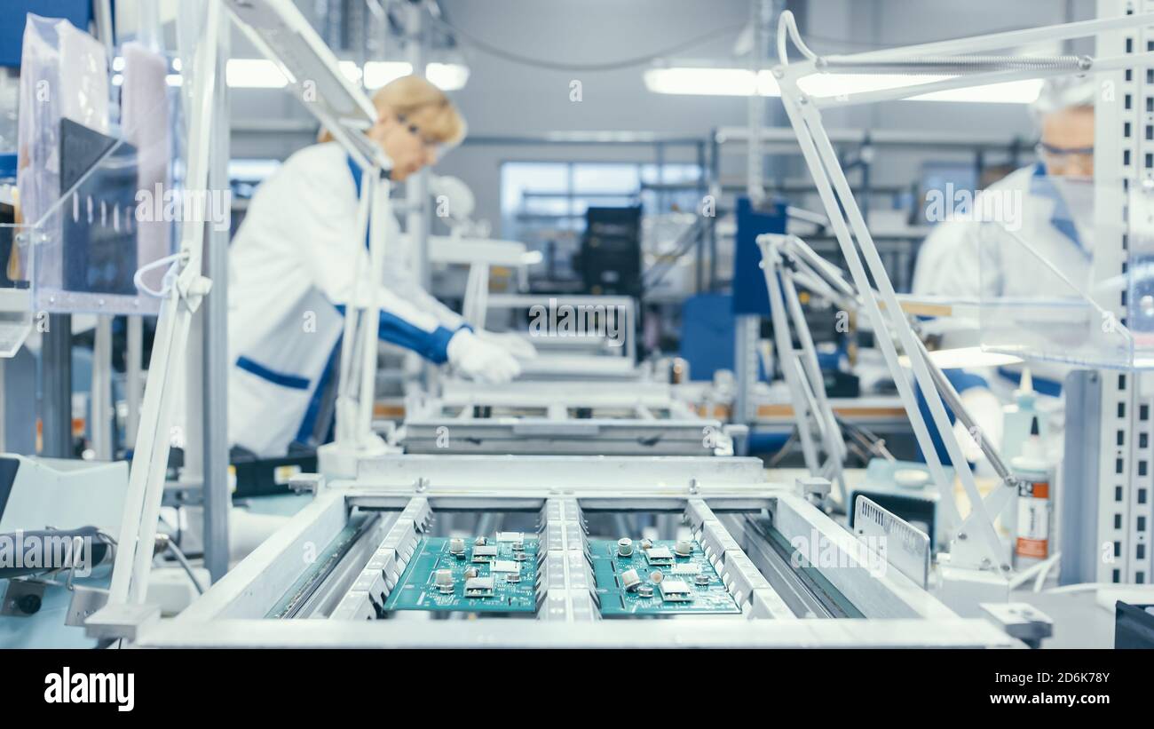 Shot of an Electronics Factory Workers Assembling Circuit Boards by ...