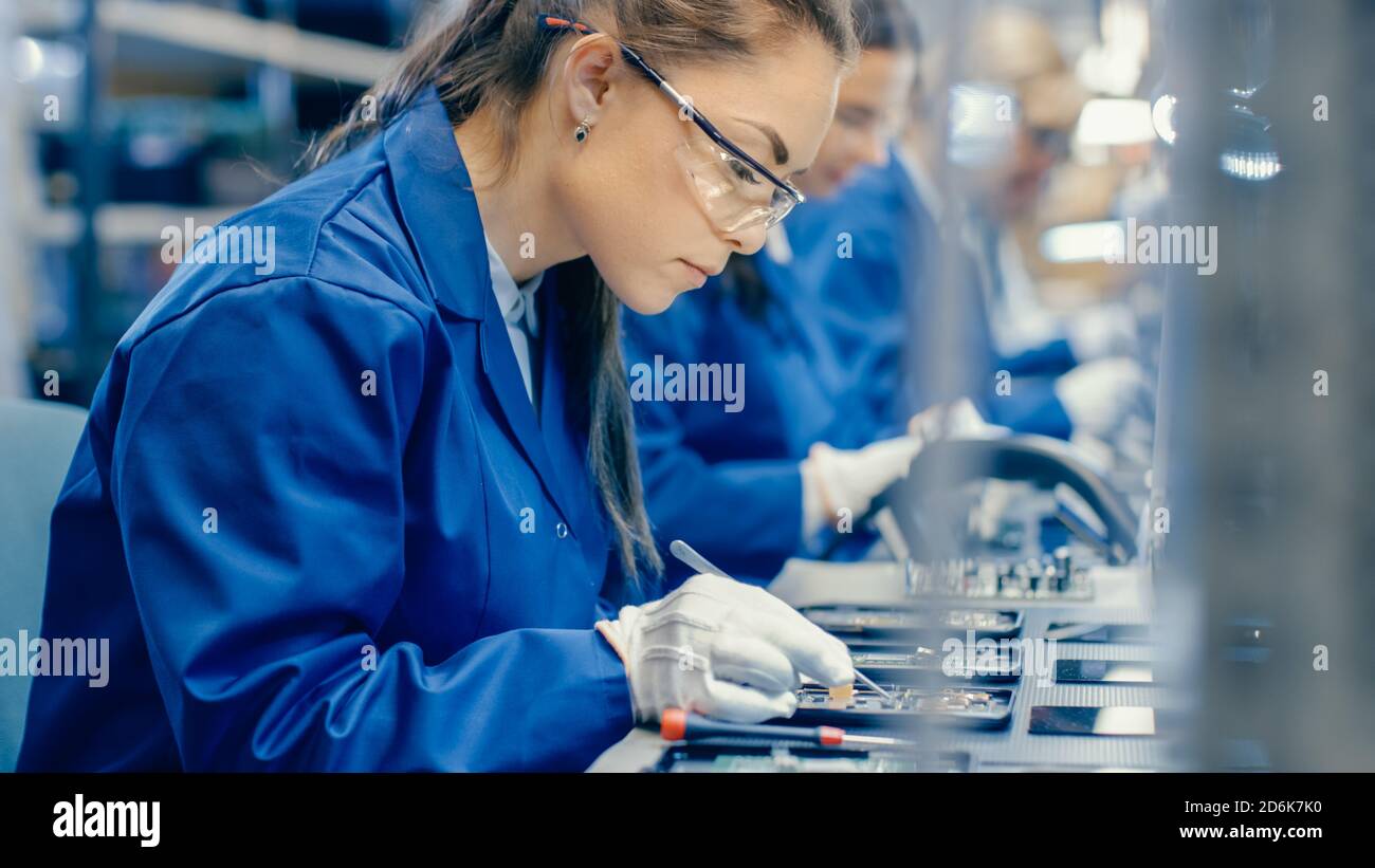 Female Electronics Factory Workers in Blue Work Coat and Protective ...