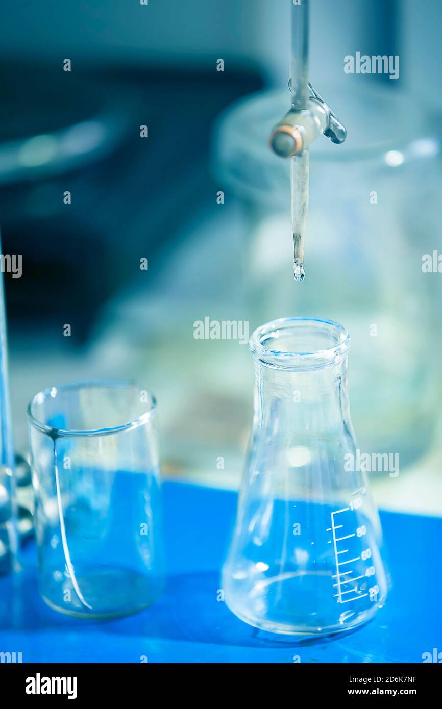 A drop of water drips into a glass test tube Stock Photo - Alamy