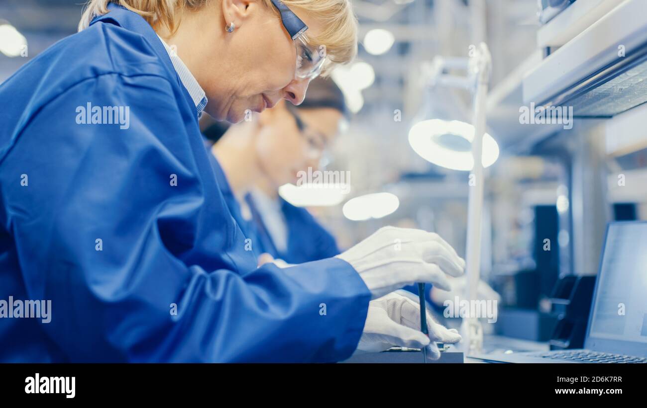 Female Electronics Factory Worker in Blue Work Coat and Protective ...