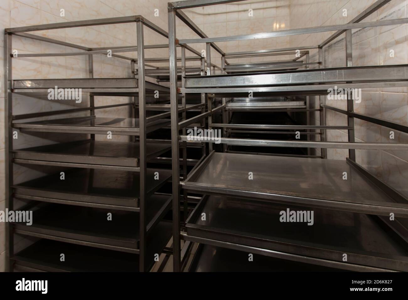 Empty metal pallets in production. Metal production carts Stock Photo ...