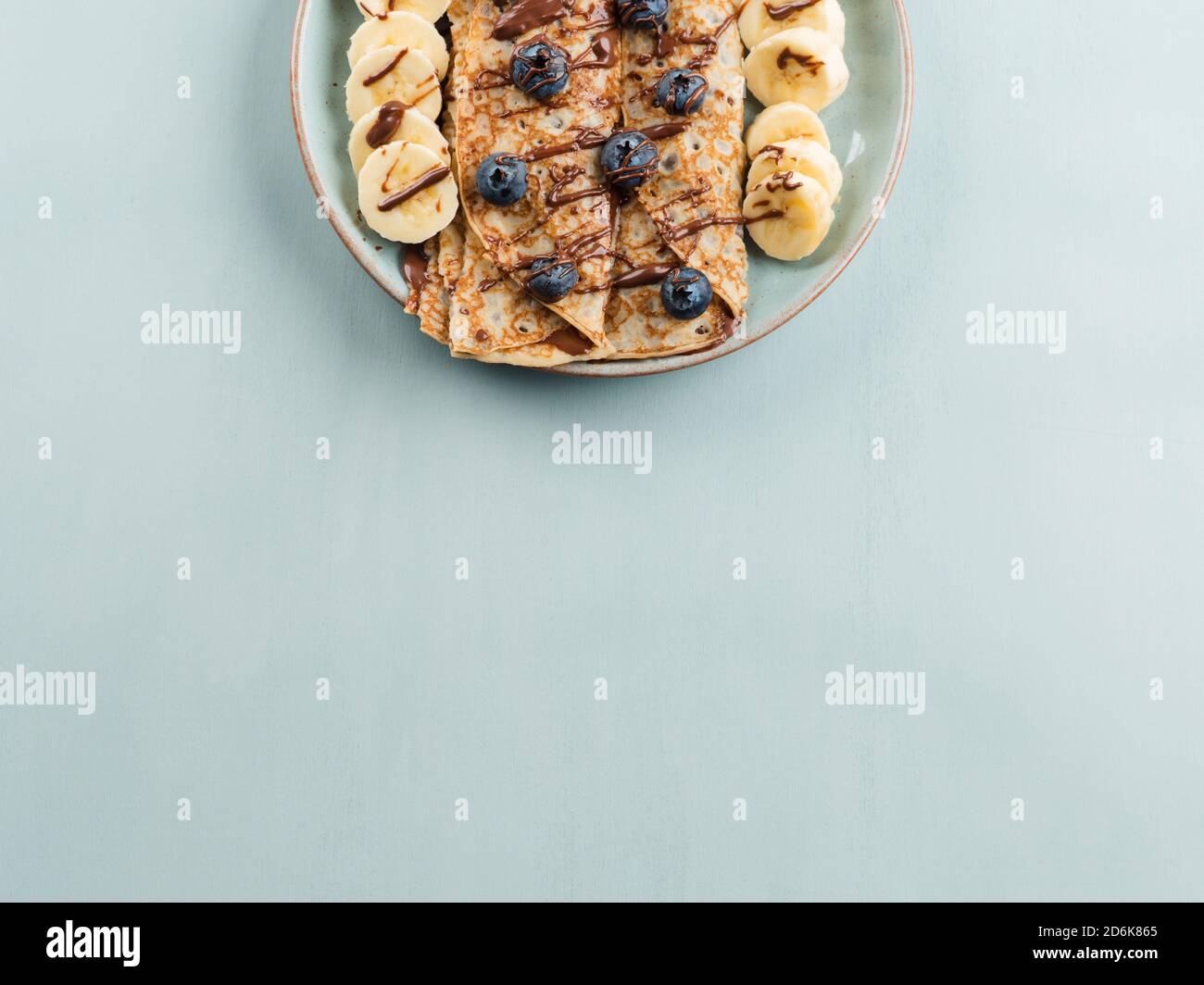 Crepes with chocolate nut spread, banana, berries Stock Photo - Alamy