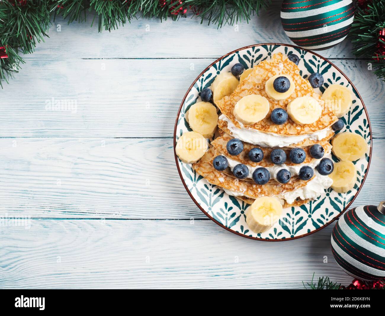 Christmas tree shaped sweet crepe with blueberries Stock Photo - Alamy