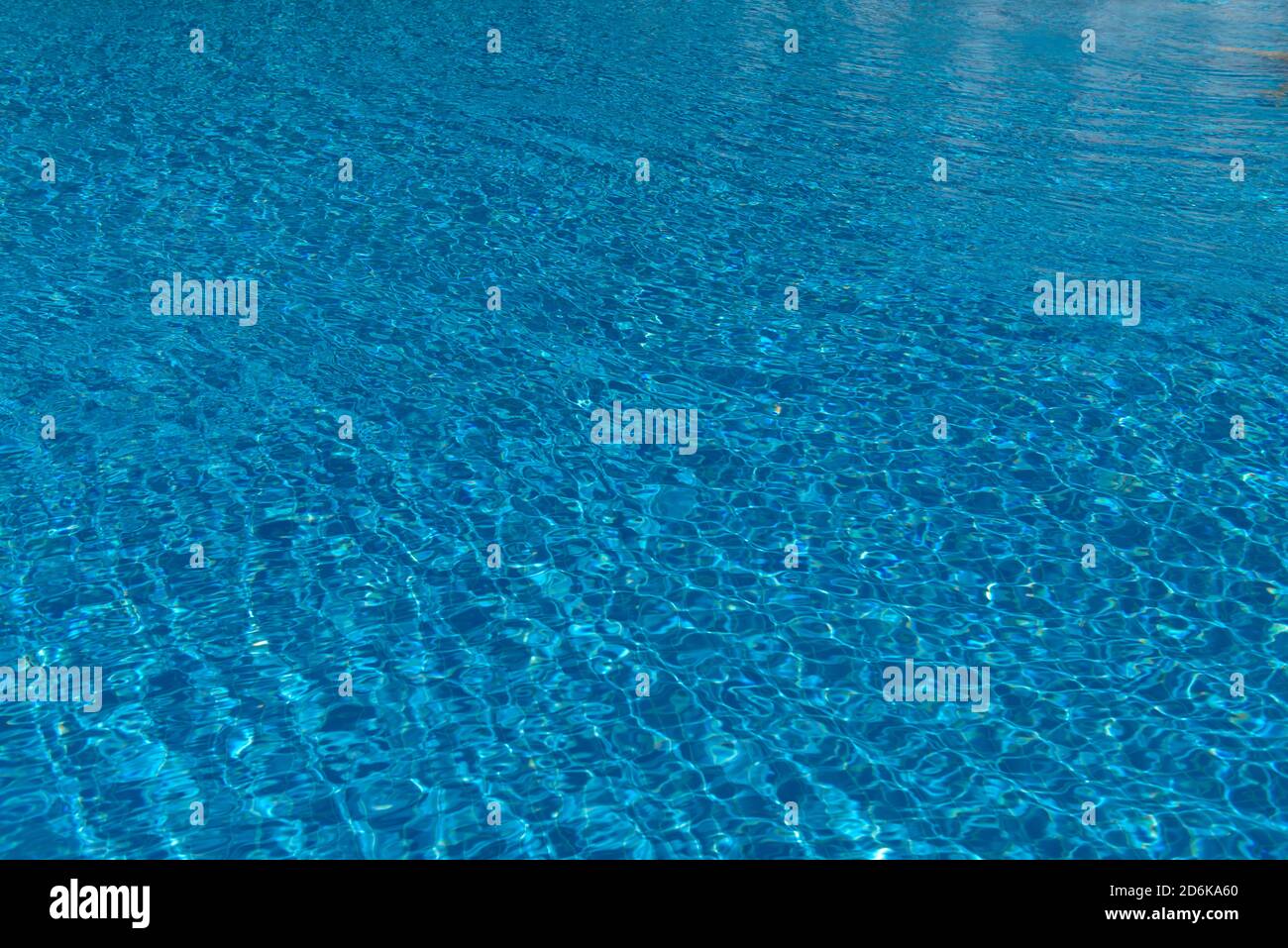 Blue water in the pool with solar reflections. Swimming pool. Water ...