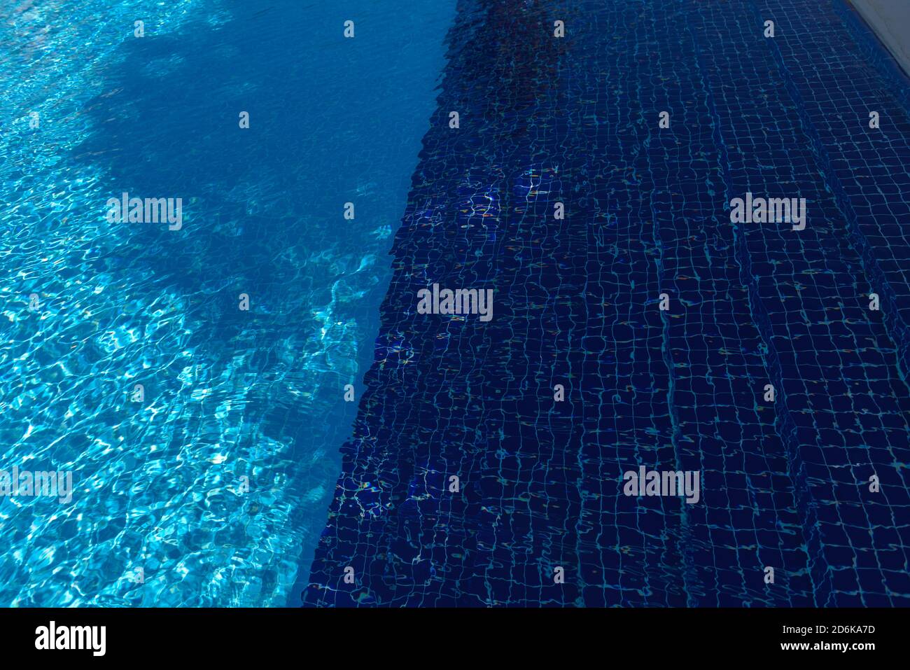 Blue water in the pool with solar reflections. Swimming pool. Water ...