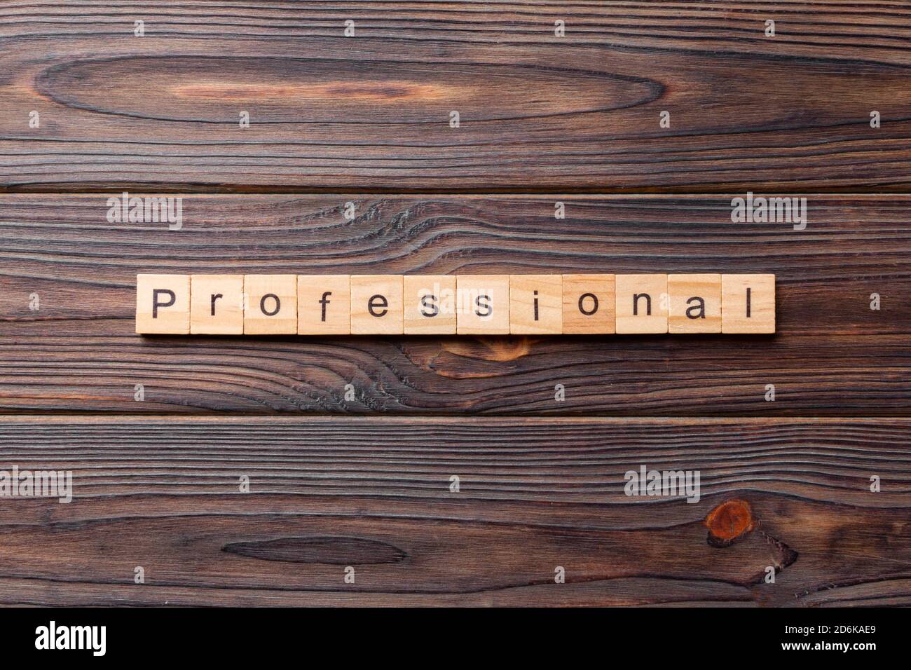 Professional word written on wood block. Professional text on cement ...