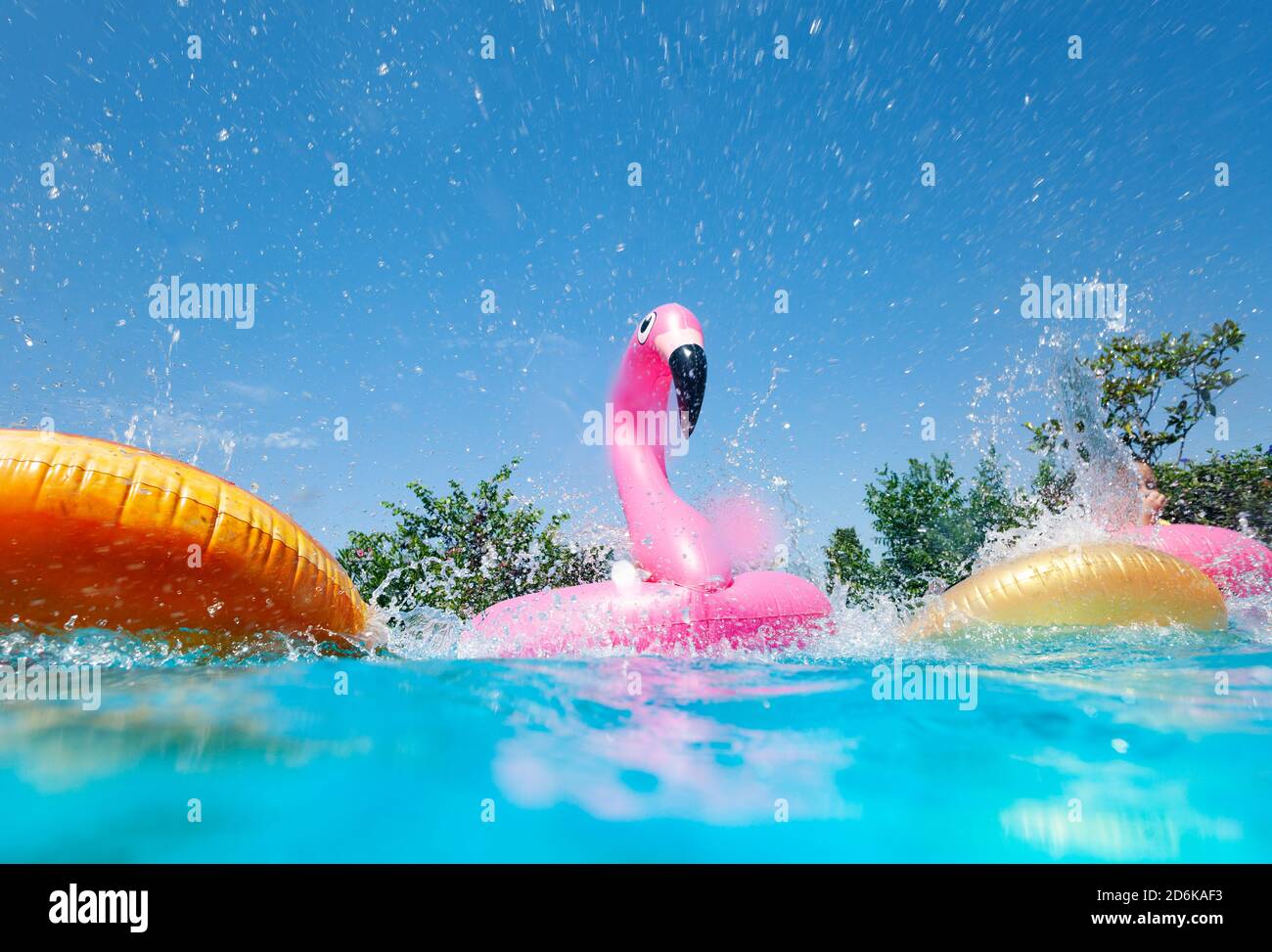 Funny action photo in the outdoor swimming pool with splashes of ...