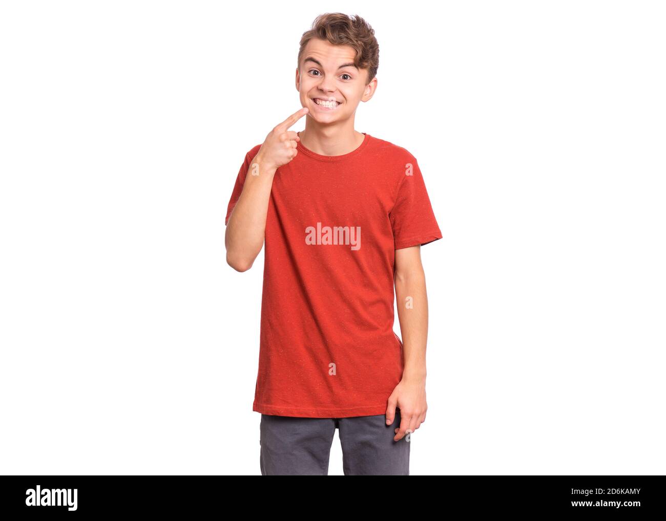Handsome teen boy showing his to teeth, isolated on white background ...