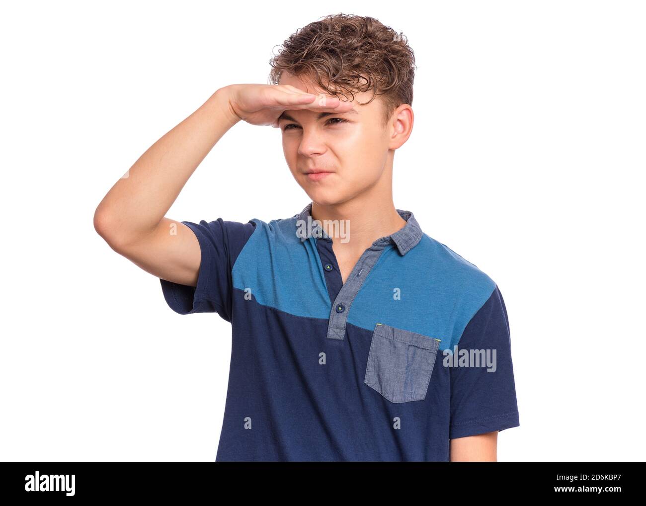Handsome guy looking into the distance, holding his hand near his eyes ...