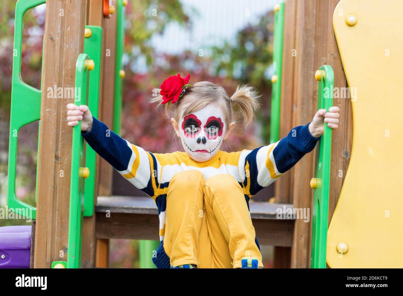 A little girl with Painted Face, shows funny faces on Mexican Day of ...