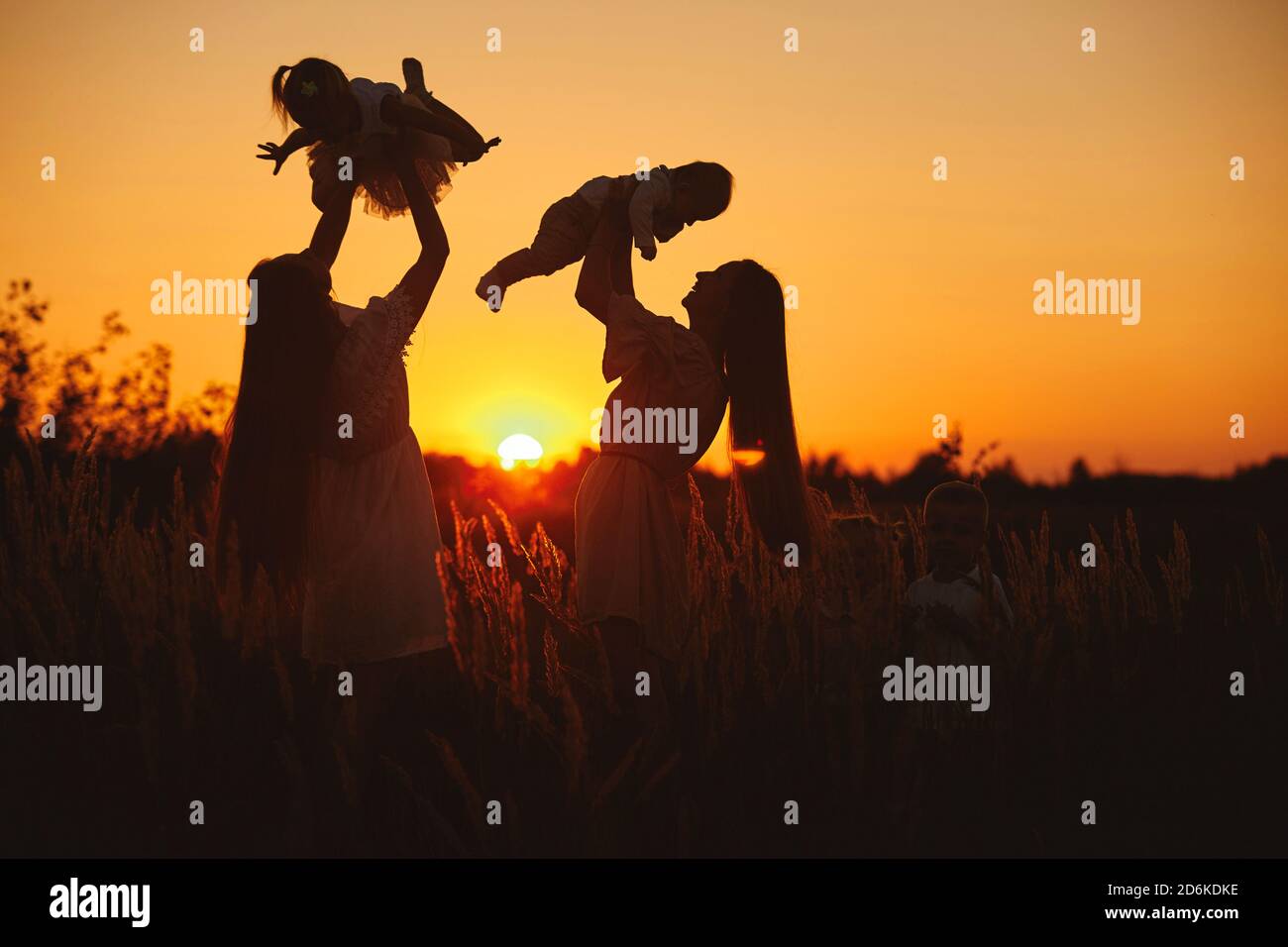 happy young moms playing with their kids outdoors in summer. Happy ...