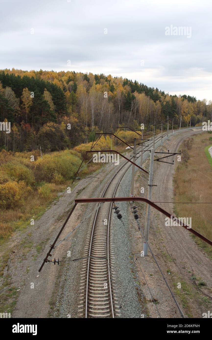 railway with rails for trains embankment from above through the forest ...